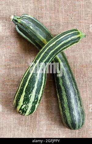 Fresh striped zucchini on sackcloth background with copy space Stock ...