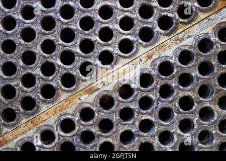 Tube sheet or plate of heat exchanger boiler closeup selective focus ...