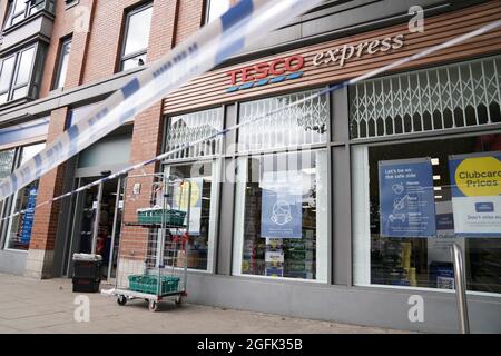 Police tape blocks the entrance to Little Waitrose on Fulham Palace ...
