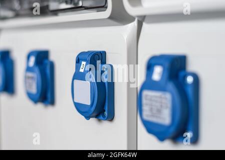Industrial sockets on distribution board with circuit breakers. Construction site electricity ...