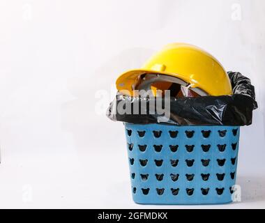 Photo of engineer helmet in a plastic trash bin Stock Photo - Alamy