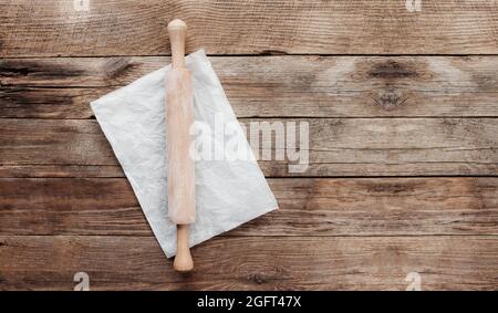 Plank with baking parchment in kitchen. Composition of kitchen devices ...