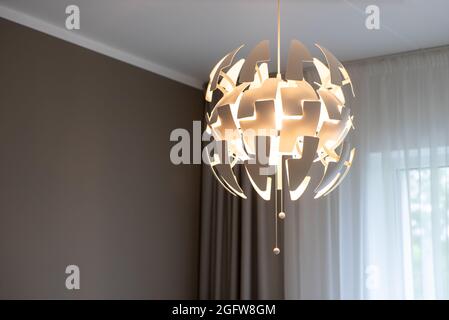 Modern interior of bedroom. Burning lamp on wooden nightstand Stock ...