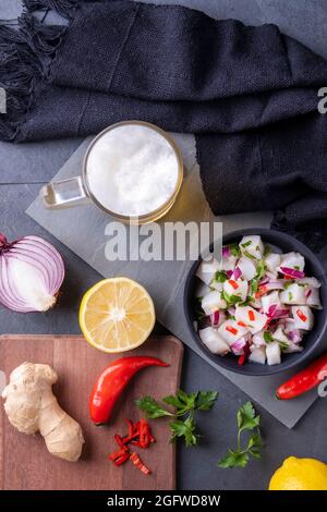 a bowl of ceviche and a mug of cold beer Stock Photo - Alamy