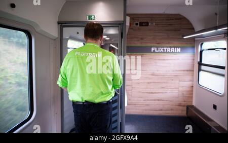 Hamburg, Germany. 24th Aug, 2021. A woman walks through a Flixtrain during a trip from Hamburg ...