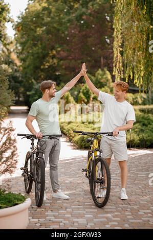 Two athletic people greeting each other with high five gesture during ...