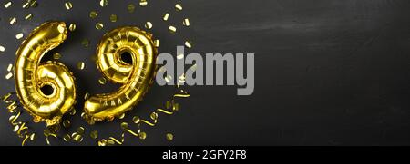 Gold number 69 (number sixty-nine) with perforated black metal ...