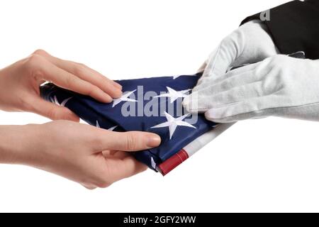 Folded into triangle American flag on memorial marble tomb with R.I.P ...