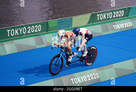 Great Britain's Alison Peasgood and guide Nikki Bartlett cross the line ...