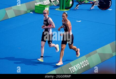 Great Britain's Alison Peasgood and guide Nikki Bartlett cross the line ...