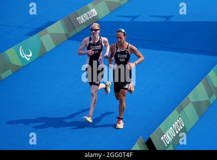 Great Britain's Alison Peasgood and guide Nikki Bartlett cross the line ...