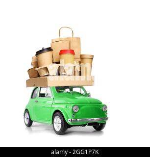 Retro toy car delivering food order on wooden table. Copy space Stock ...