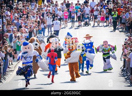 Mascot race at the Scottish Coal Carrying Championships through the ...