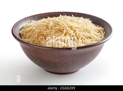 Uncooked vermicelli pasta in ceramic bowl on white wooden background ...