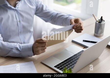 Hands of businessman opening paper envelope, taking out letter Stock ...