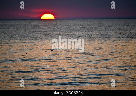 The fantastic sunset over the Welsh coastal resorts of West Wales Stock ...