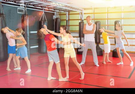 Children practicing self defence technique in pairs Stock Photo - Alamy