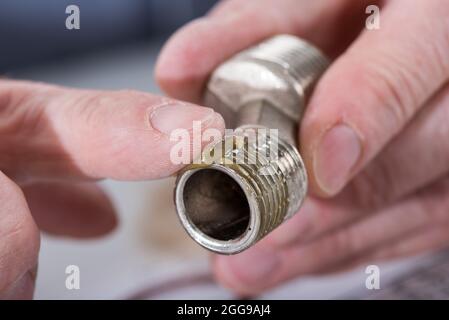 Plumber putting sealing paste on a thread, closeup. panoramic banner ...
