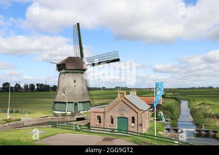Mill in a polder landscape Stock Photo - Alamy
