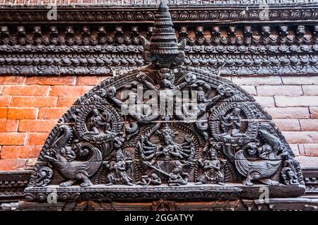 Wooden carved torana, decorated lintel of a door in Kumari Ghar, palace ...