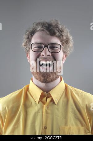 Portrait of an adult laughing Hungarian ginger man with a beard and ...