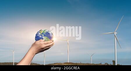 Hands holding eco concept with windmill generators Stock Photo - Alamy