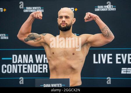 Matheus Scheffel steps on the scale for the official weigh-ins at ...