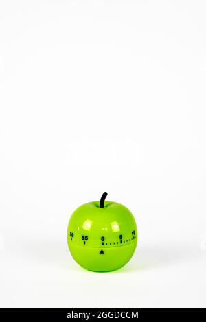 An apple-shaped kitchen timer isolated on light blue background Stock ...