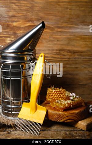 smoker for bees on a wooden background. Breeding bees and extracting ...