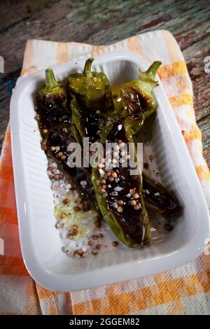 Presentation of a bunch of baked green peppers flavored with juniper ...