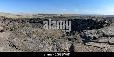 Basalt, extrusive igneous volcanic rock specimen on white background ...