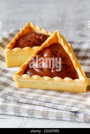 Chocolate triangles cakes. Party dessert Stock Photo - Alamy