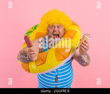 Fat man with beard and wig eats a popsicle and an icecream Stock Photo ...