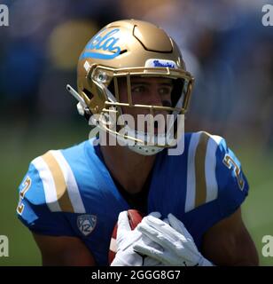 UCLA running back Keegan Jones, left, runs for a touchdown as Colorado ...