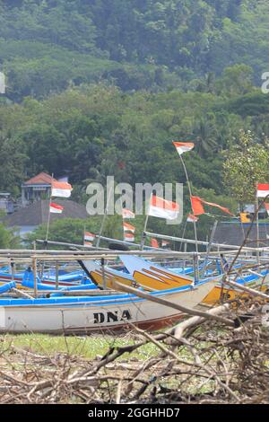 PACITAN, INDONESIA - August 22, 2021: A fishing boat with a red and ...