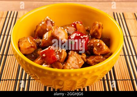 chess chicken in yellow bowl on wooden background - chinese food Stock ...