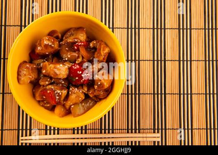 chess chicken in yellow bowl on wooden background - chinese food Stock ...