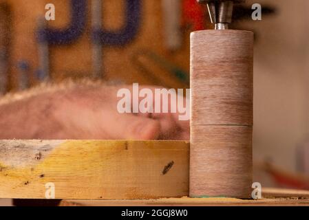 Wood artisan sanding guitar body, creating musical instrument in ...