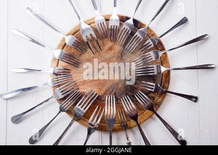 Sets of forks different shapes arranged on chopping round Stock Photo ...