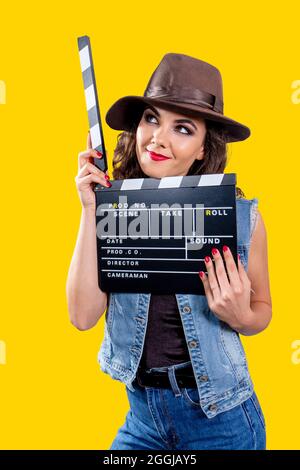 woman holding movie clapper against green background Stock Photo - Alamy