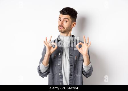 Not bad. Impressed handsome guy nod in approval, showing okay signs to ...