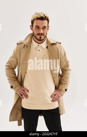 man fashionable hairstyle beige coat side glance isolated background Stock Photo - Alamy