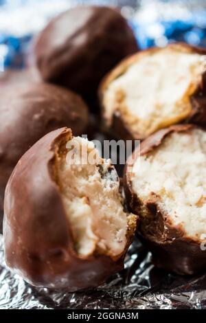 Vertical closeup shot of unwrapped half-eaten chocolate candies Stock ...