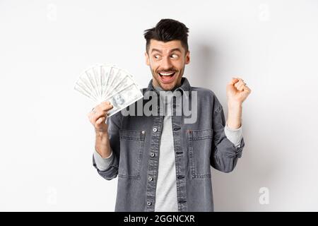 Lucky man winning prize money and scream of excitement, staring at ...