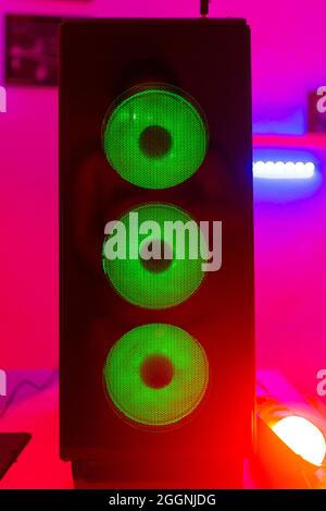 Colorful led lights of computer fan shines through the protective grid ...