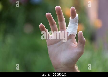 Teenager's bandaged finger after cut Stock Photo - Alamy