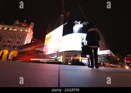 A lady stands in Piccadilly Circus in London. Picture date: Thursday ...