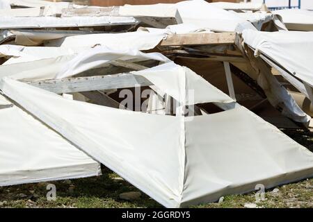 beach umbrellas lie on the beach after a hurricane. natural disaster ...