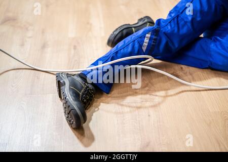 Electrician Man Cable Trip Injury. Slip And Fall Accident Compensation ...