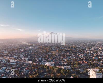 Aerial view of sunset Mount Merapi and Yogyakarta city, Indonesia. City ...